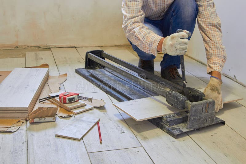 Cut the Tile with a Cutter, Construction Worker Cuts Tiles on the Floor ...