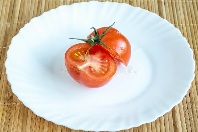 Cut tomato on white plate stock photo. Image of agriculture - 91519692