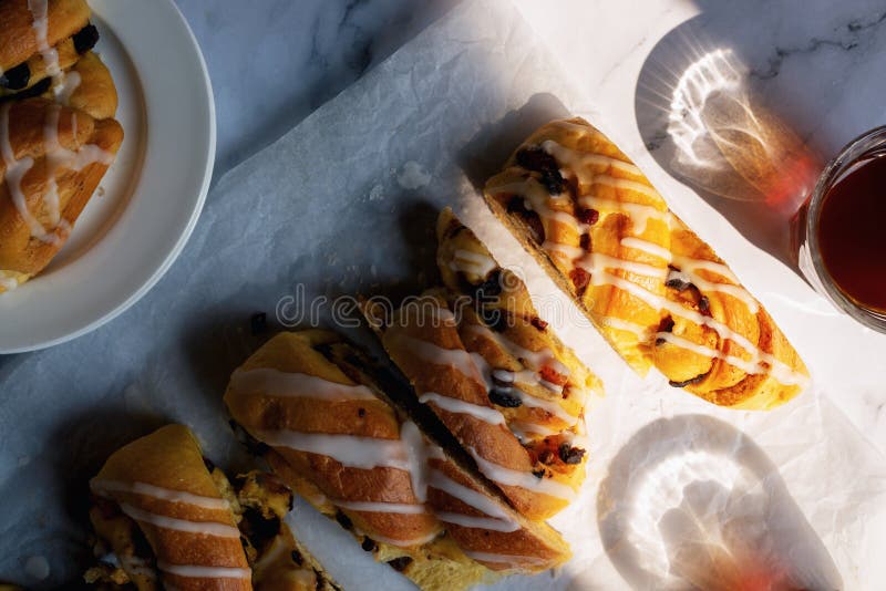 Cut Up Cinnamon Mixed Fruit Bun on a Baking Paper in Sunlight Stock ...