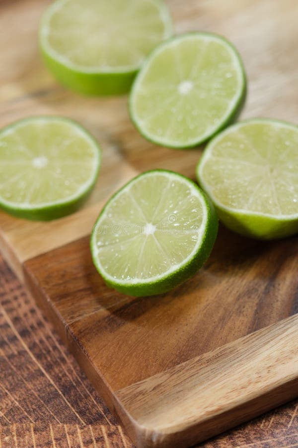 Cut Up Lime on the Cutting Board Stock Photo - Image of table, food ...
