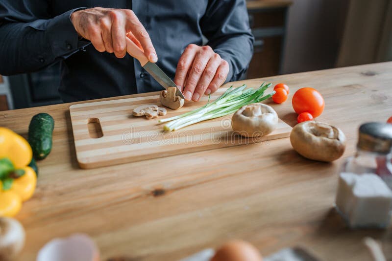 Cut View of Man` Hands Cutting Mushrooms with Knife. he Work with Both ...