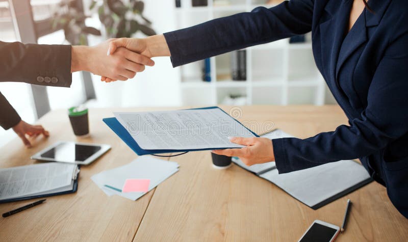 Cut View of Man and Woman Shaking Hands. she Hold Folder with Papers ...