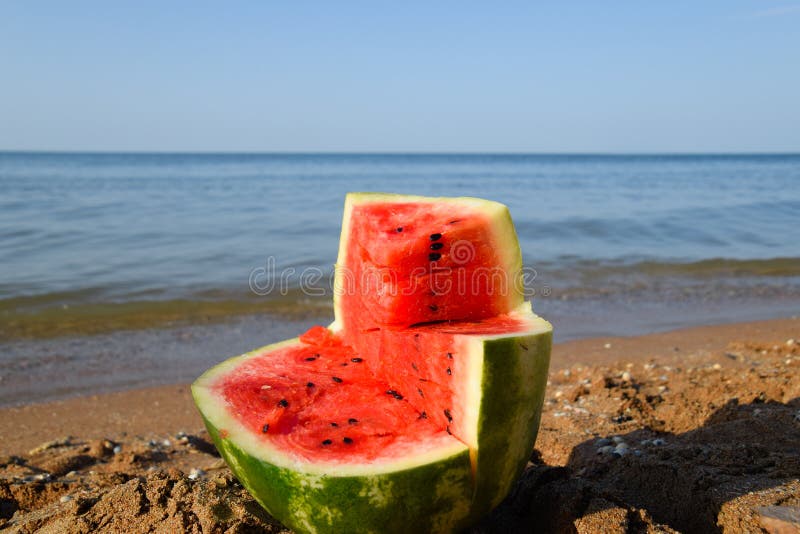 The Cut Watermelon Lies on the Seashore. Watermelon in the Sea Stock ...