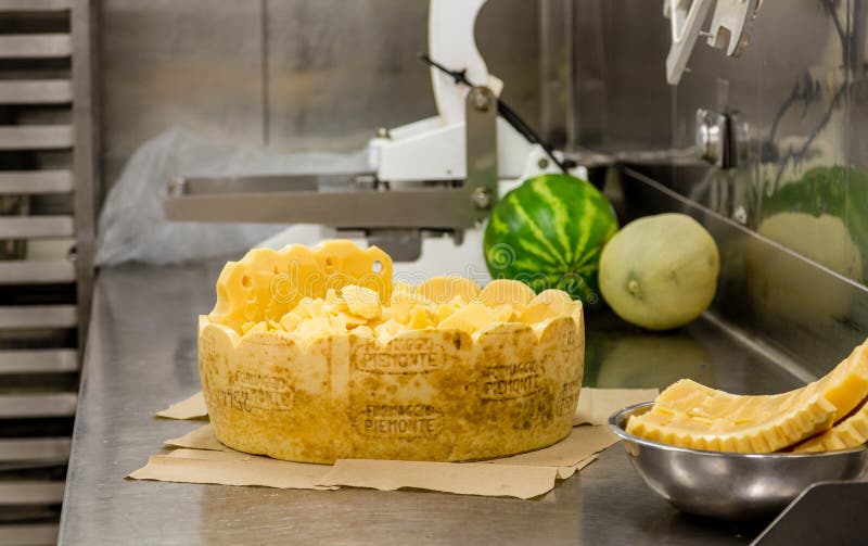 Cut Wheel of Cheese in Commercial Kitchen Stock Photo - Image of round ...