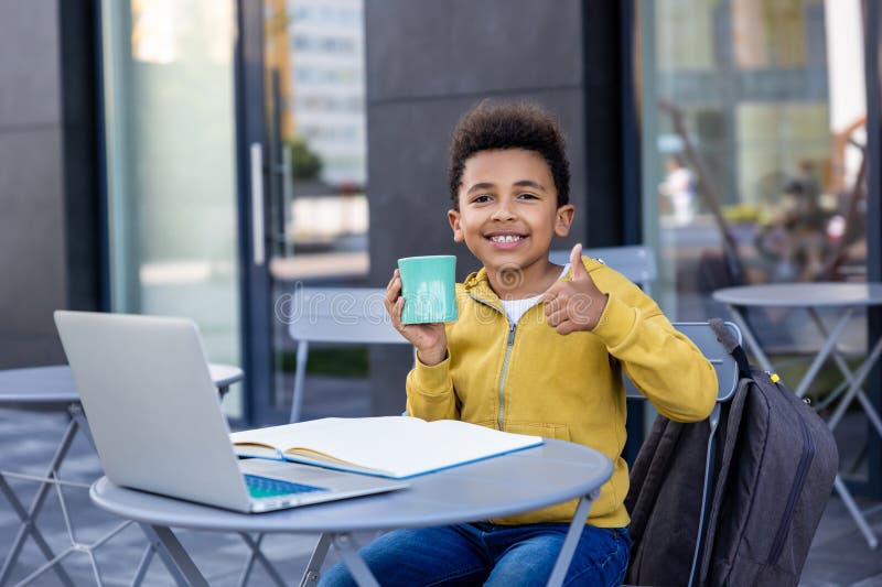 Cute African American Boy with a Cup in Hand Looking Contented Stock ...