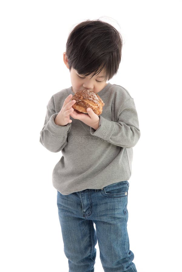 Cute Asian Boy Eating Cream Puff Stock Photo - Image of child ...