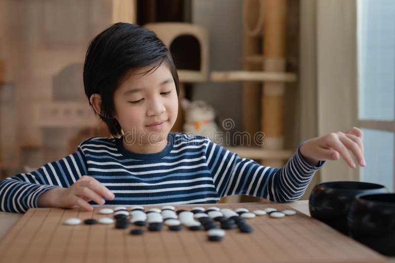 Asian Boy Learned To Play Chinese Go Game Stock Image - Image of black ...