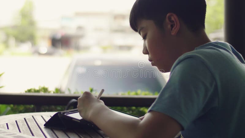 Cute Asian Boy Using Tablet Computer, Young Teenage Boy Doing Homework ...
