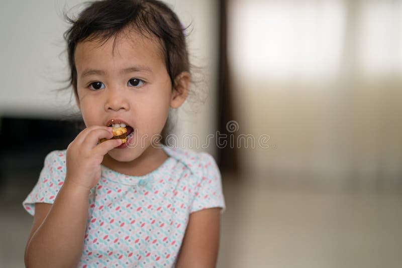 Cute Asian Female Child Eating a Cookie Stock Image - Image of little ...