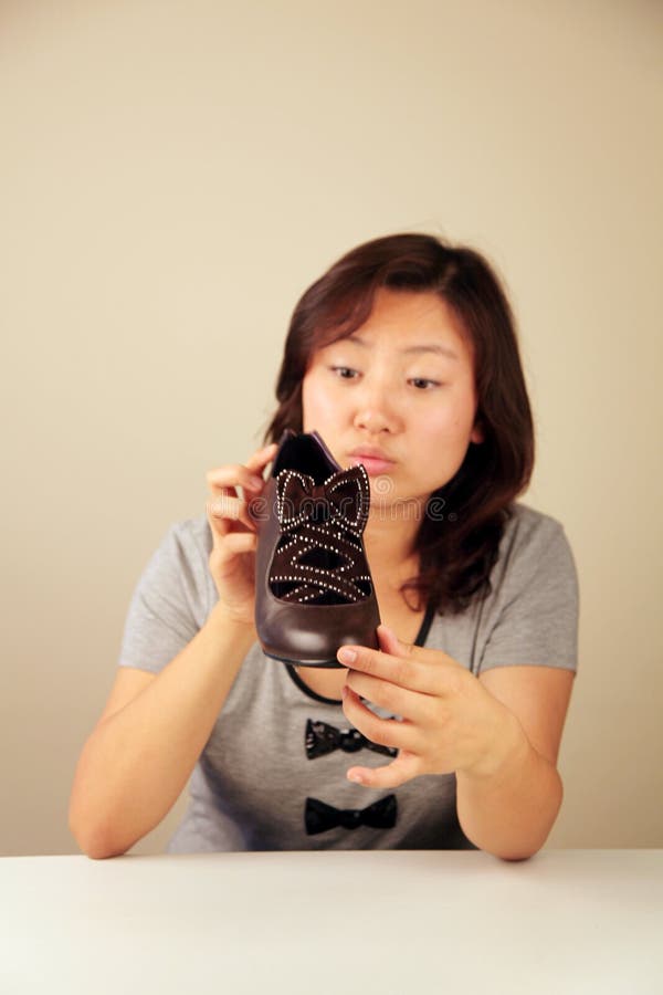 Cute Asian Girl Looking at a Shoe Stock Photo - Image of face ...