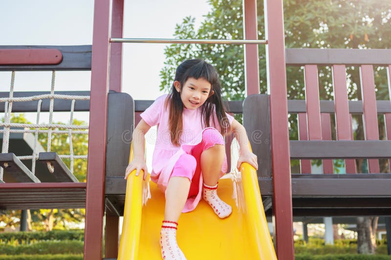 Asian Girl Playing on the Slide in the Playground Stock Image - Image ...
