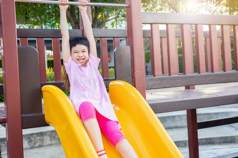 Girl Playing on the Slide in the Playground Stock Image - Image of park ...