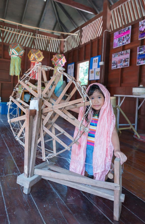 Cute Asian Girl is Using Spinning Wheel. Stock Photo - Image of white ...