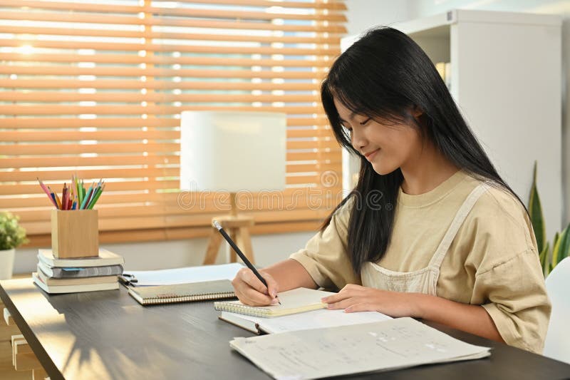 Cute Asian Teenage Student, Doing Homework, Writing Task, Taking Notes ...