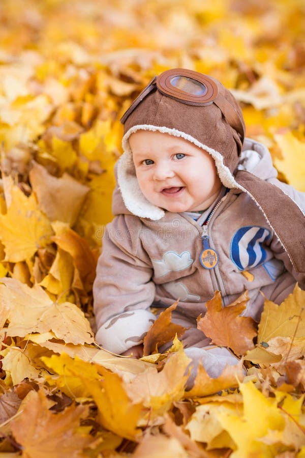Cute Baby in Autumn Leaves. Stock Photo - Image of leaves, outdoors ...