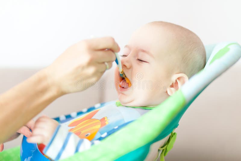 Cute baby boy being fed stock image. Image of enjoying - 55073949