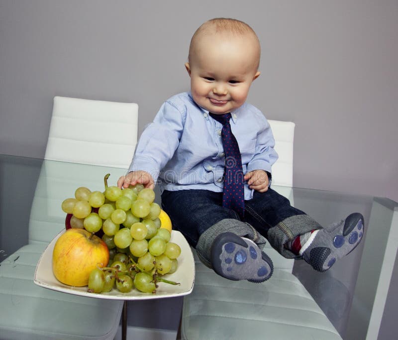 Cute Baby Boy Eating Fruits Stock Photo - Image of happiness, nutrition ...