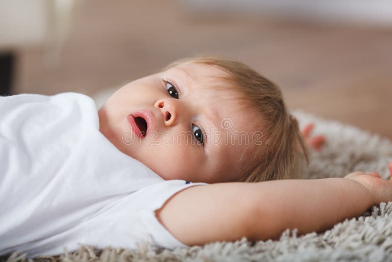Cute Baby Boy Laying on Carpet Floor Stock Image - Image of attitude ...