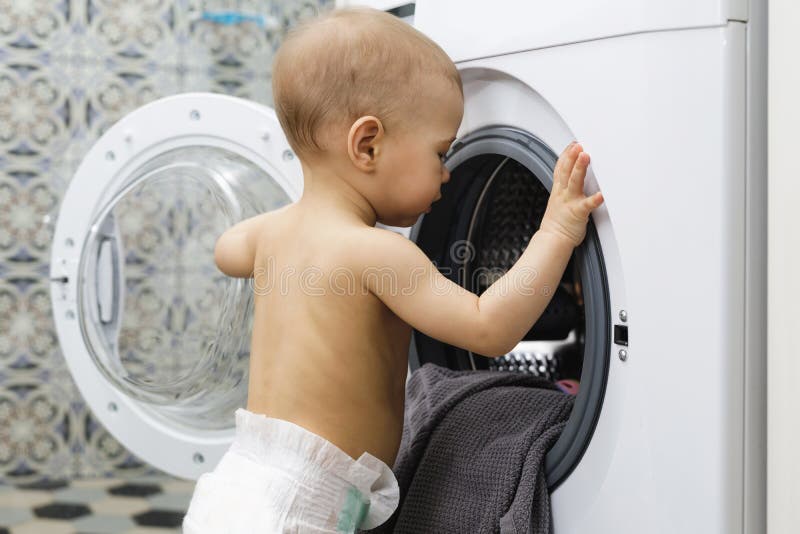 Cute Baby Boy is Looking Inside the Washing Machine Stock Image - Image ...