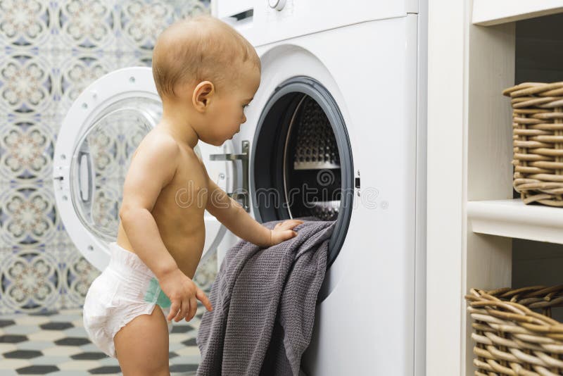 Cute Baby Boy is Looking Inside the Washing Machine Stock Image - Image ...