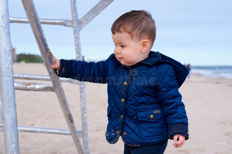 Cute Baby Boy Playing on the Beach on a Cold Day Stock Photo - Image of ...