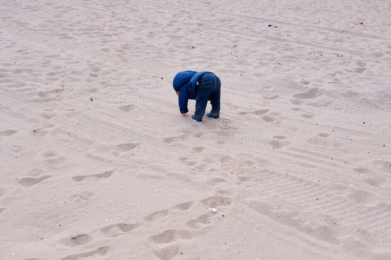 Cute Baby Boy Playing on the Beach on a Cold Day Stock Image - Image of ...