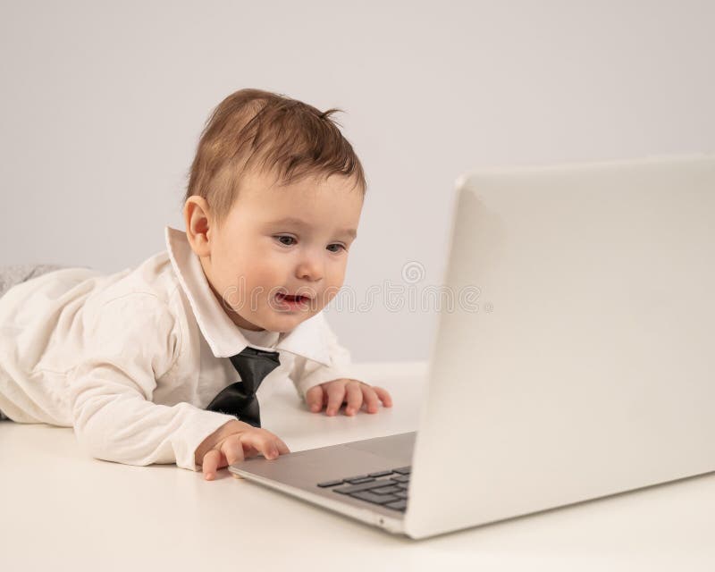 Cute Baby Boy in a Tie Working at a Laptop. Stock Photo - Image of ...