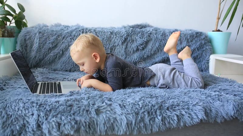 Cute Baby Boy Typing on Laptop, Playing with Computer on Sofa. Stock ...