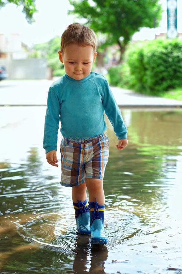 Cute Baby Boy Walking through the Puddle Stock Image - Image of legs ...