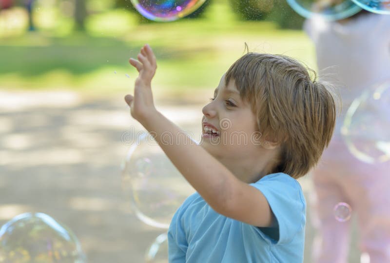 Cute Baby Catching Soap Bubbles Stock Photo - Image of beautiful ...