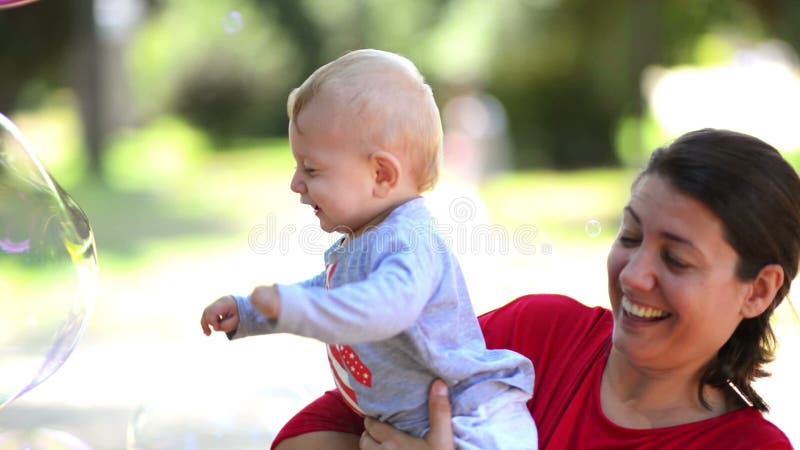 Cute Baby Girl Covered in Bath Towel with Mother Looking in His ...