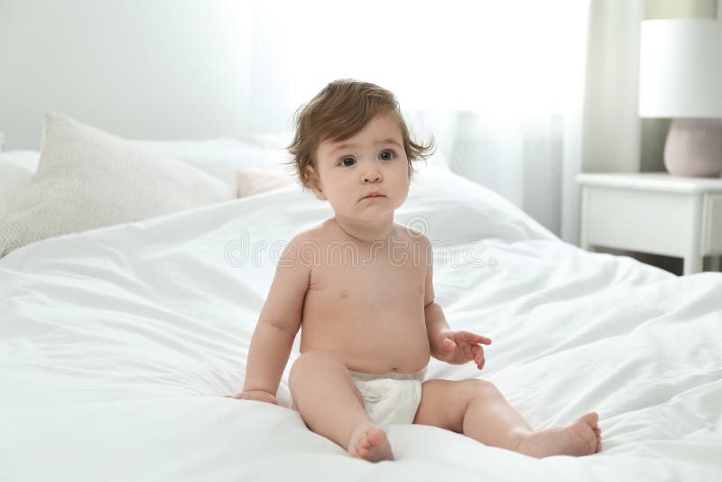 Cute baby in diaper on bed stock image. Image of beautiful - 182622391