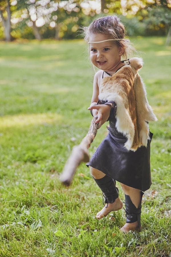 Cute Baby Dressed in the Clothes of Primitive People with Combat Staff ...
