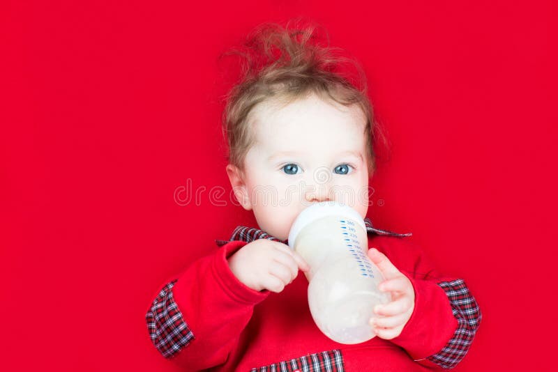Cute Baby Drinking Milk on a Red Blanket Stock Image - Image of dairy ...