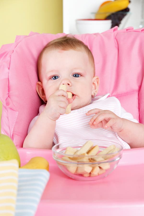 Cute baby eating snack stock image. Image of nice, chair - 49777909