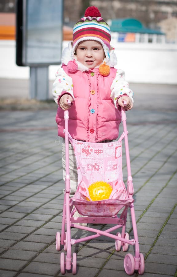 Cute Baby Girl with Toy Stroller Stock Photo - Image of city ...