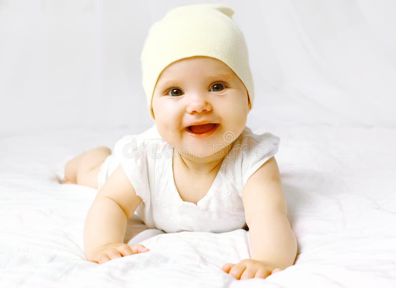 Cute Baby in Hat on the Bed Stock Photo - Image of laugh, beautiful ...