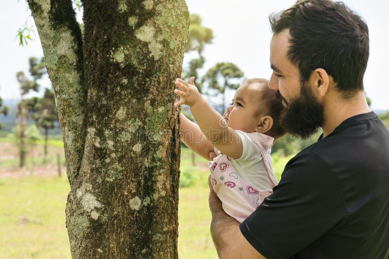 Cute Baby Hugging a Tree Trunk in the Spring Forest Stock Image - Image ...