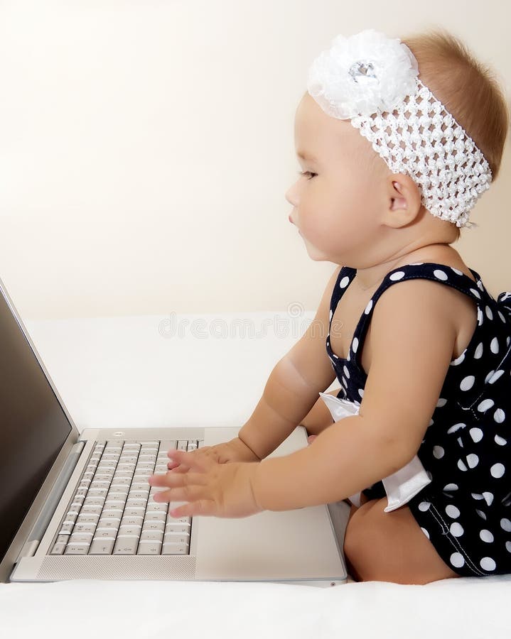 Cute baby with a laptop. stock image. Image of computer - 46512695