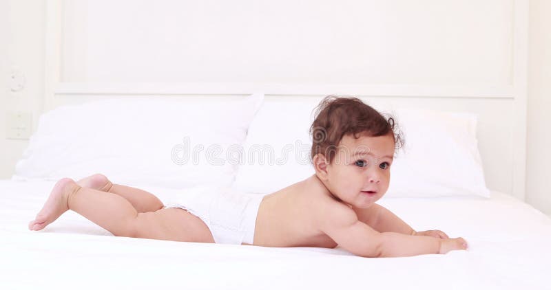 Cute baby playing on bed stock image. Image of bonding - 347442157