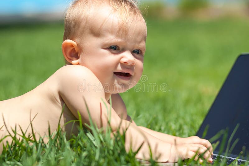 Cute Baby Playing with Laptop Outdoors on Green Grass Stock Image ...