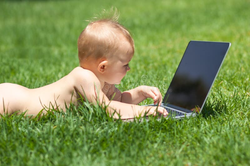 Cute Baby Playing with Laptop Outdoors on Green Grass Stock Image ...