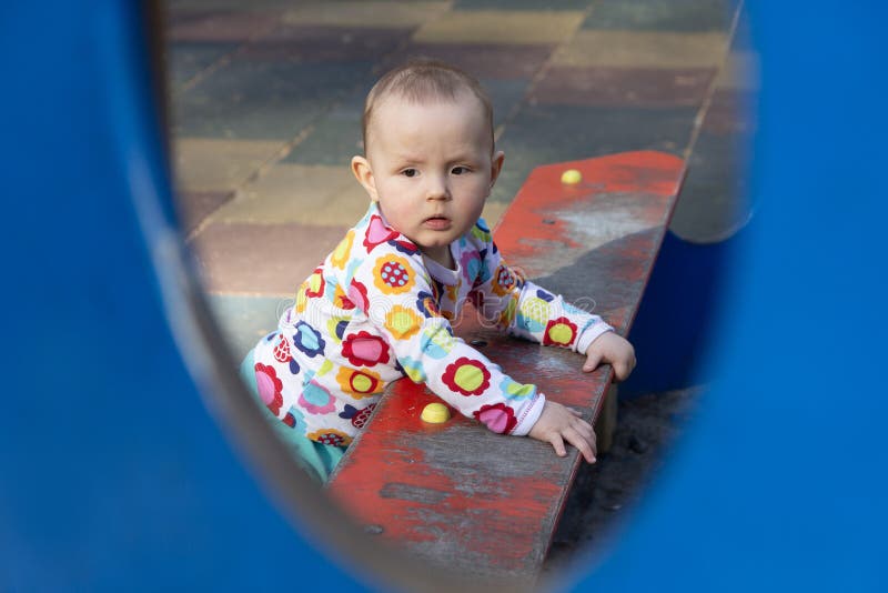 The Cute Baby Plays on the Playground in the Park Stock Photo - Image ...