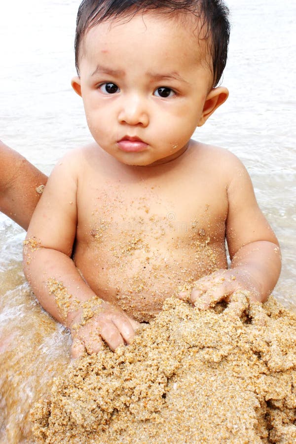 Cute baby with the sand stock image. Image of infant - 26998267