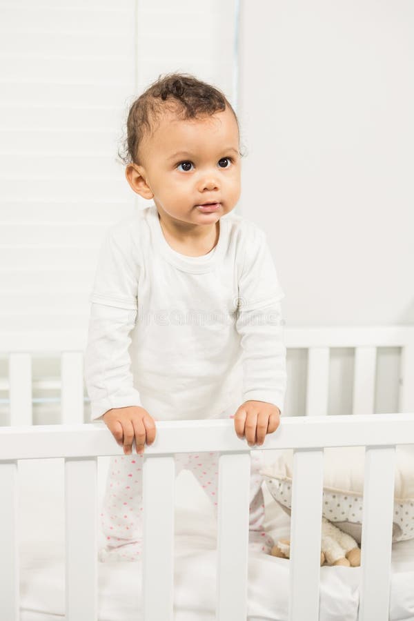 Cute Baby Standing in the Crib Stock Photo - Image of brown, bedroom ...