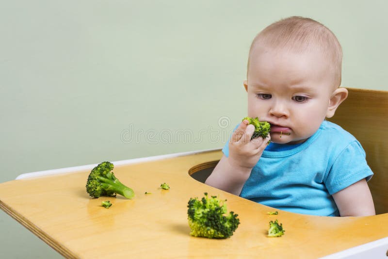 Cute baby tasting broccoli stock image. Image of beautiful - 52167027