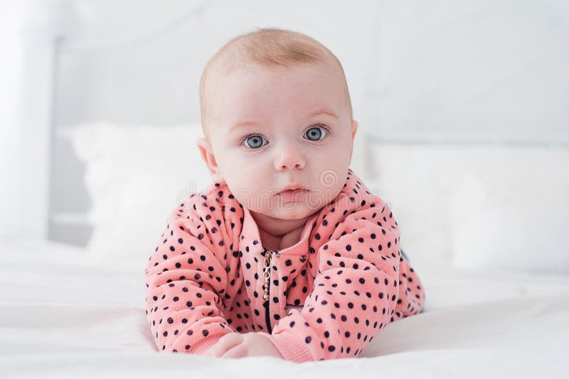 Cute baby on the white bed stock photo. Image of monthly - 92296000