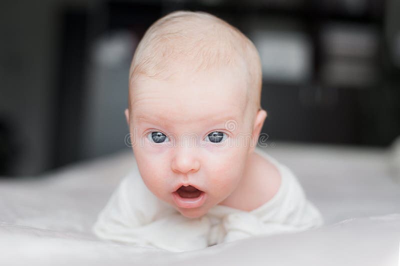 Cute baby on the white bed stock image. Image of portrait - 92296003