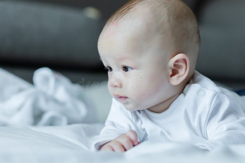 Cute Baby on White Bed. Baby, Newborn Concept Stock Image - Image of ...