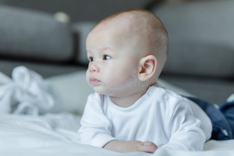Cute Baby on White Bed. Baby, Newborn Concept Stock Image - Image of ...